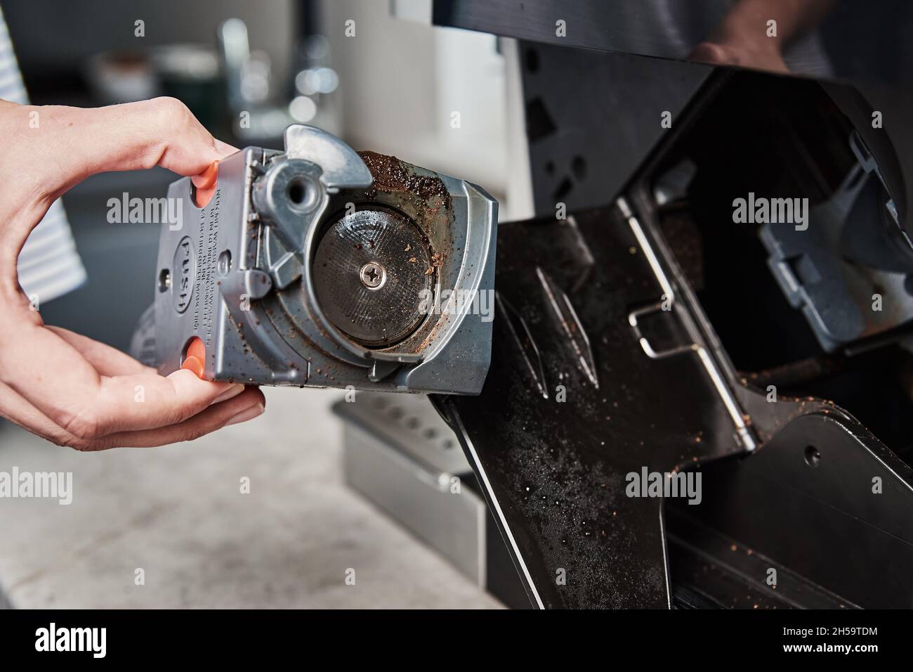 Automatic coffee machine cleaning. Woman cleans mechanism inside coffee ...