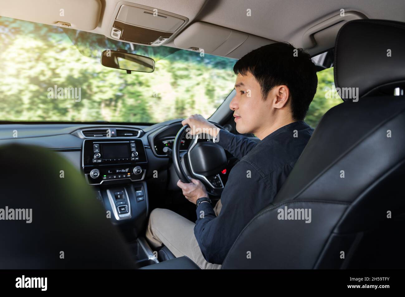 Asian businessman driving car hi-res stock photography and images - Alamy