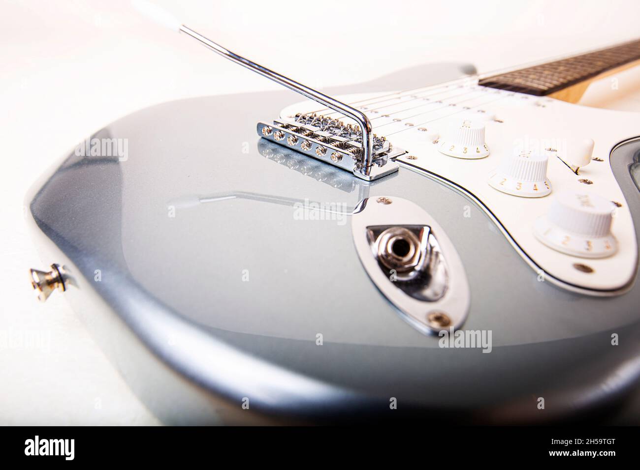 Silver electric guitar isolated on white background Stock Photo - Alamy