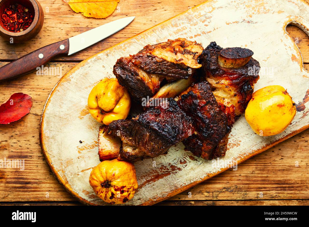 Succulent beef ribs fried with autumn quince Stock Photo - Alamy