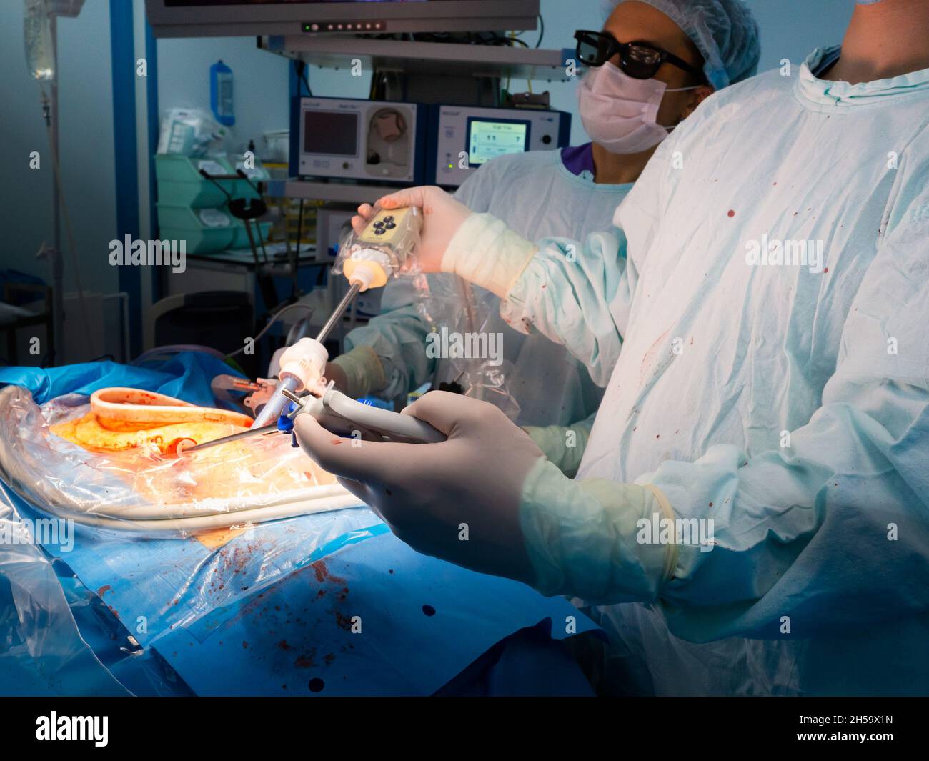 Selective focus on the hand of a surgeon with a surgical instrument ...
