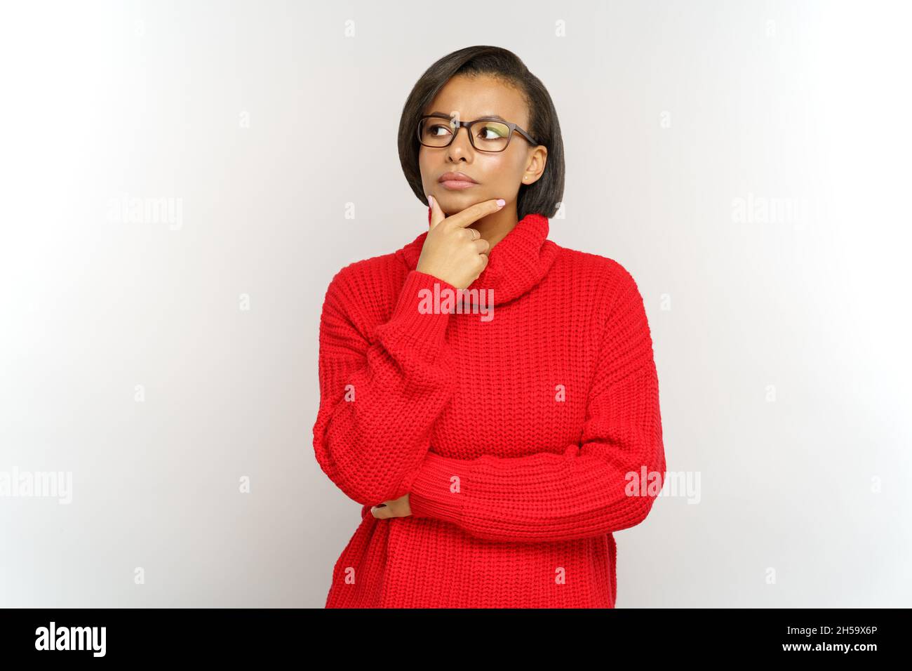 Thoughtful young woman thinking looking up, touching chin pensive make ...