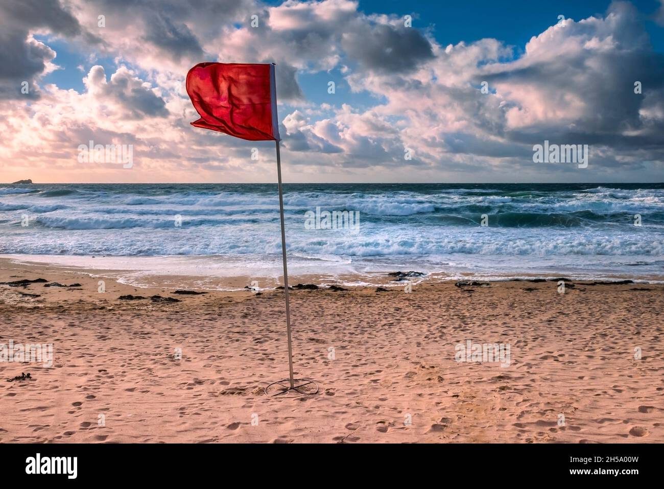A RNLI red flag for danger fluttering in high winds at Fistral Beach in ...