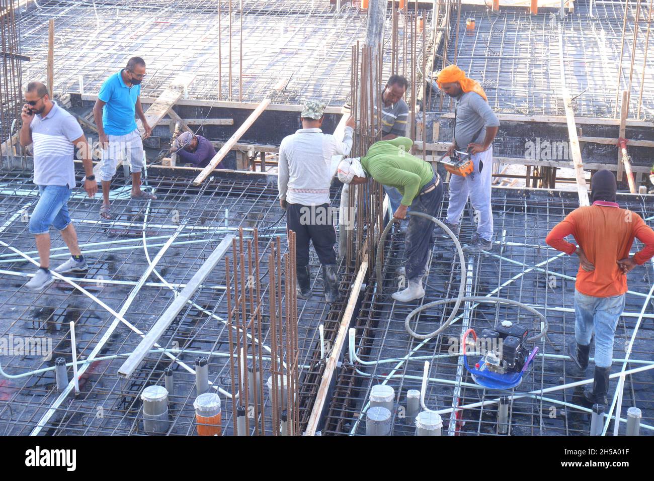 Asian construction workers working on a building, Kingdom of Bahrain ...