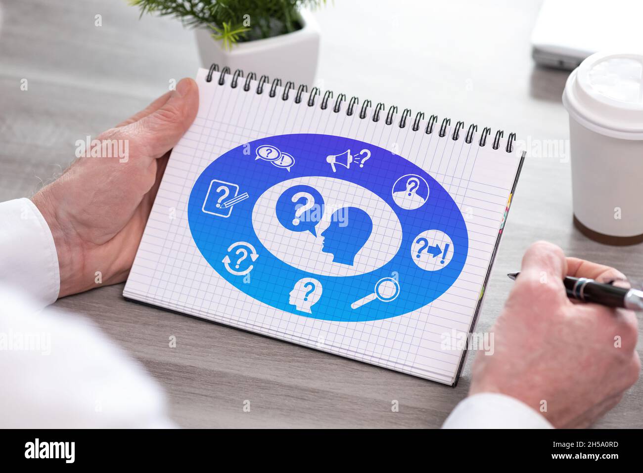 Hand holding a notepad with question concept Stock Photo - Alamy