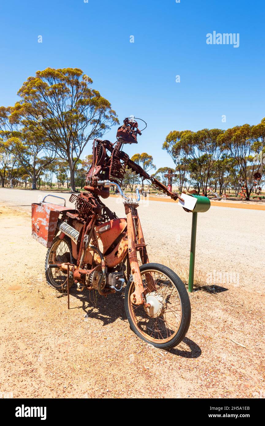 Amusing metal sculpture of a mailman delivering a letter in the small ...