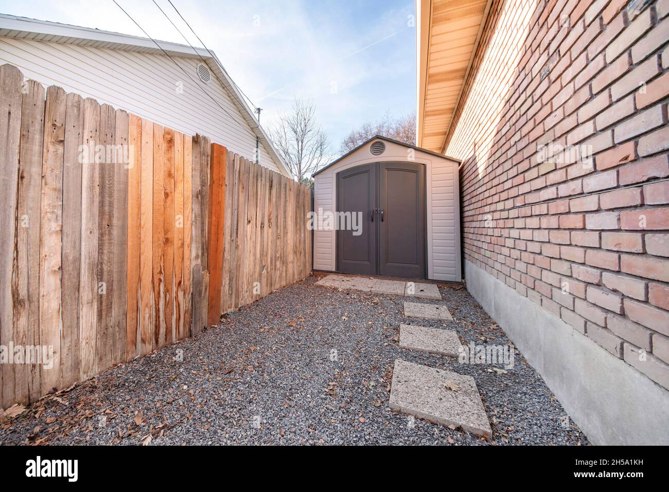 Plastic shed outside a house with concrete pathway Stock Photo - Alamy