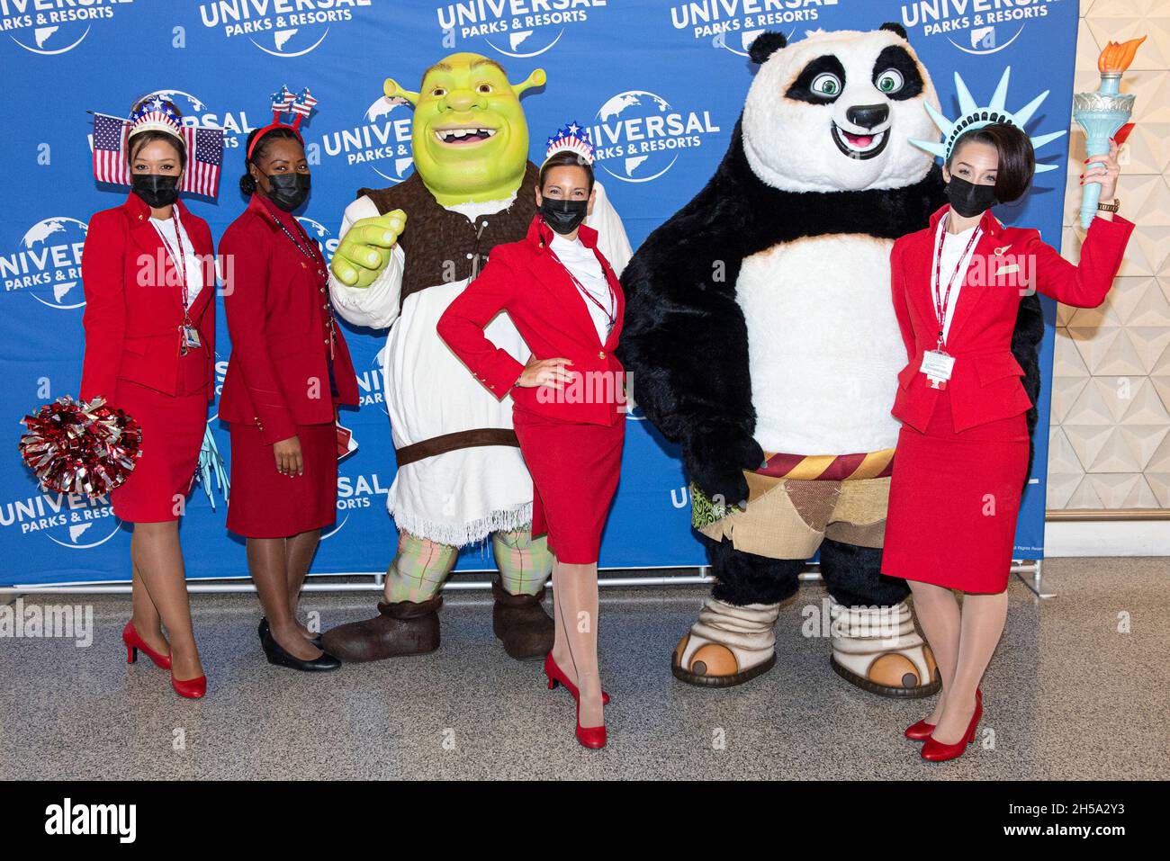 EDITORIAL USE ONLY Virgin Atlantic staff pose with Universal characters ...