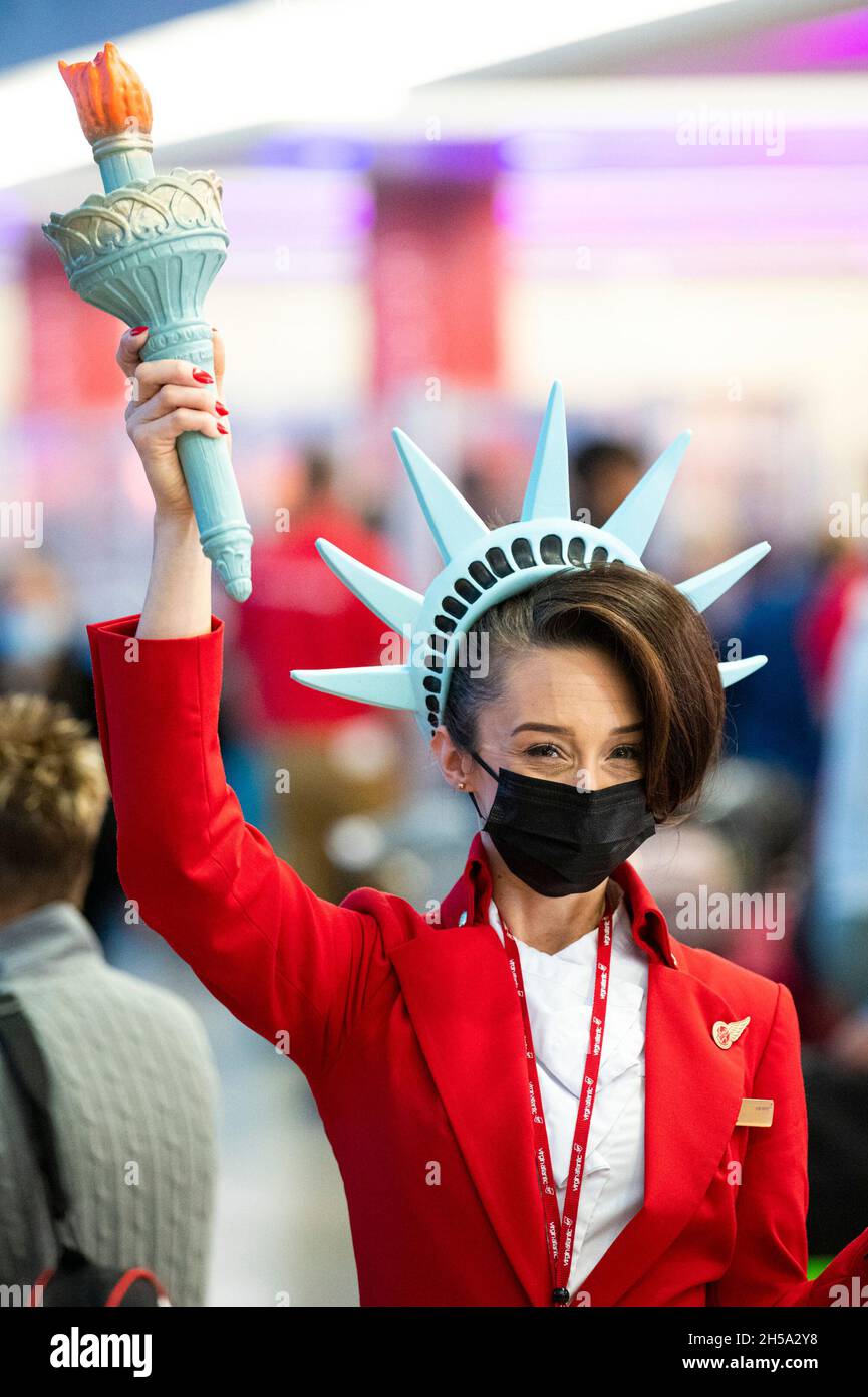 EDITORIAL USE ONLY A Virgin Atlantic staff member poses as the Statue ...