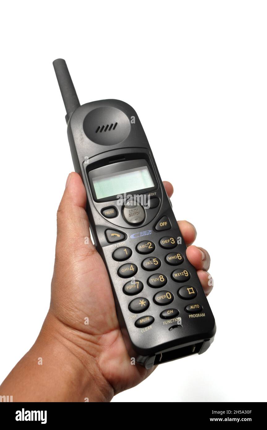 Holding cordless telephone or portable telephone white background Stock ...