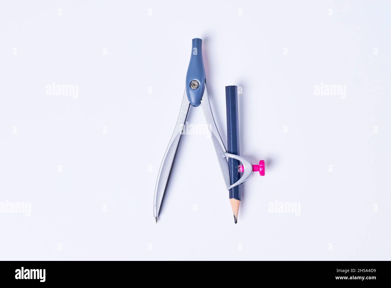 Drawing Compass with pencil on white background. A school compass with ...