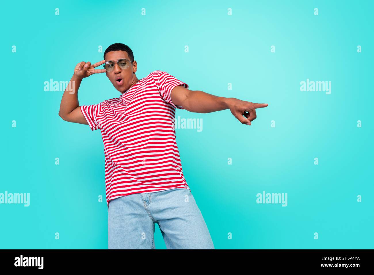 Photo of excited cute young guy dressed red t-shirt dancing pointing ...