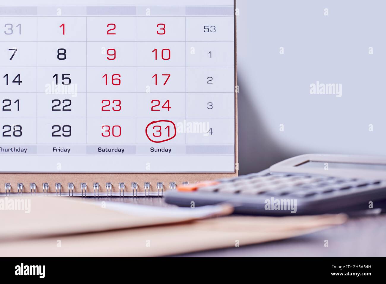 Calendar, calculator and stack of coins in office. Deadline concept ...