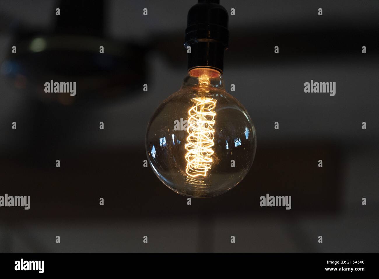 Lamp light bulb detail isolated on black background Stock Photo - Alamy