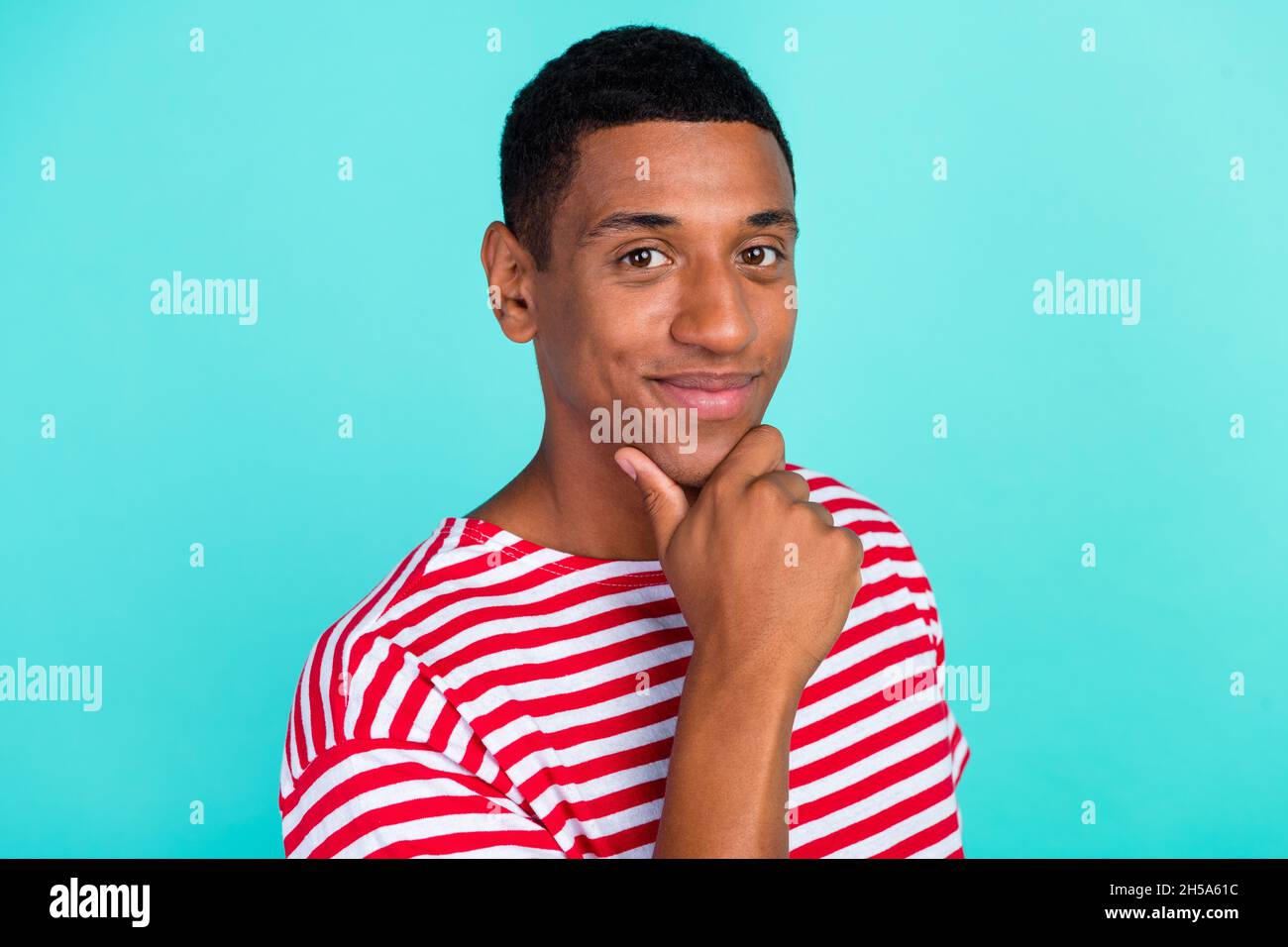Photo of thoughtful pretty young guy dressed red t-shirt arm chin ...