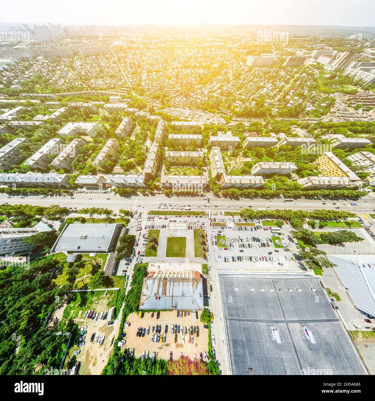 Aerial city view with crossroads and roads, houses, buildings, parks ...