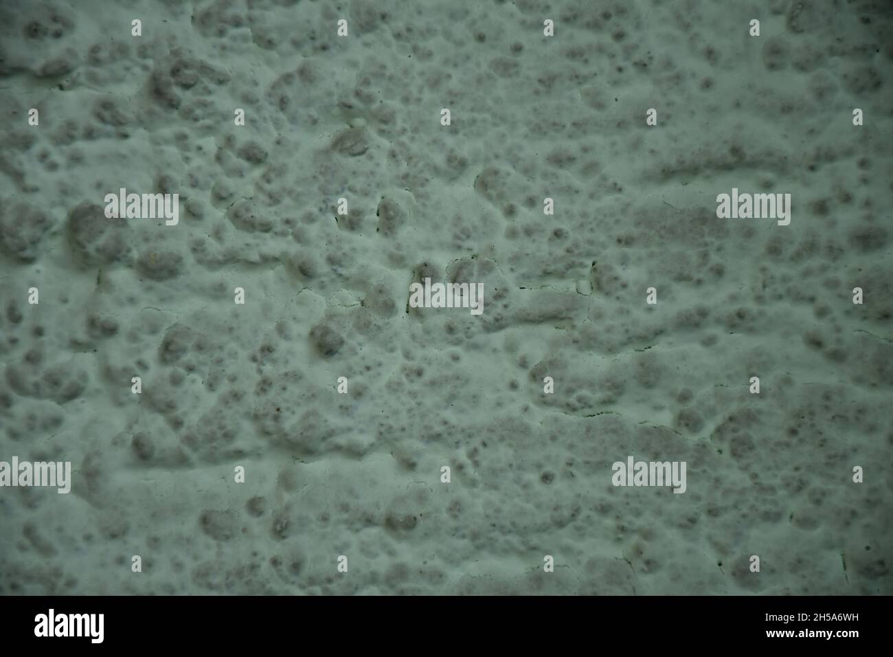 Wall of concrete with green plastering Stock Photo - Alamy