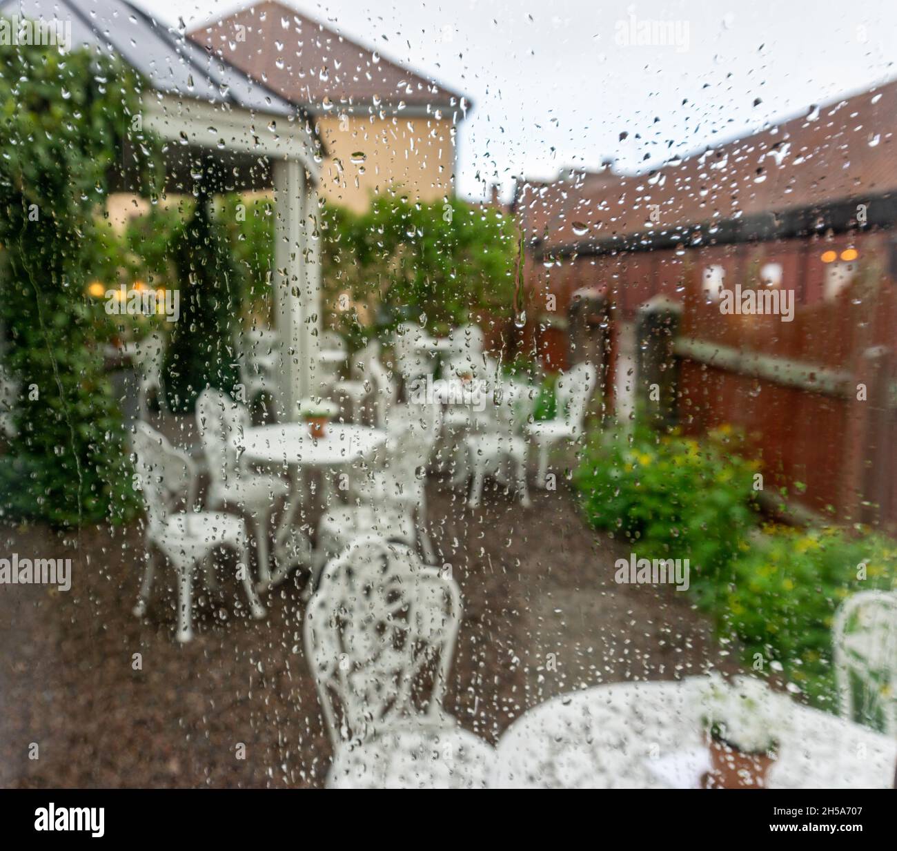 Vadstena, Sweden - May 23, 2021: Backyard of cafe during the rain with ...