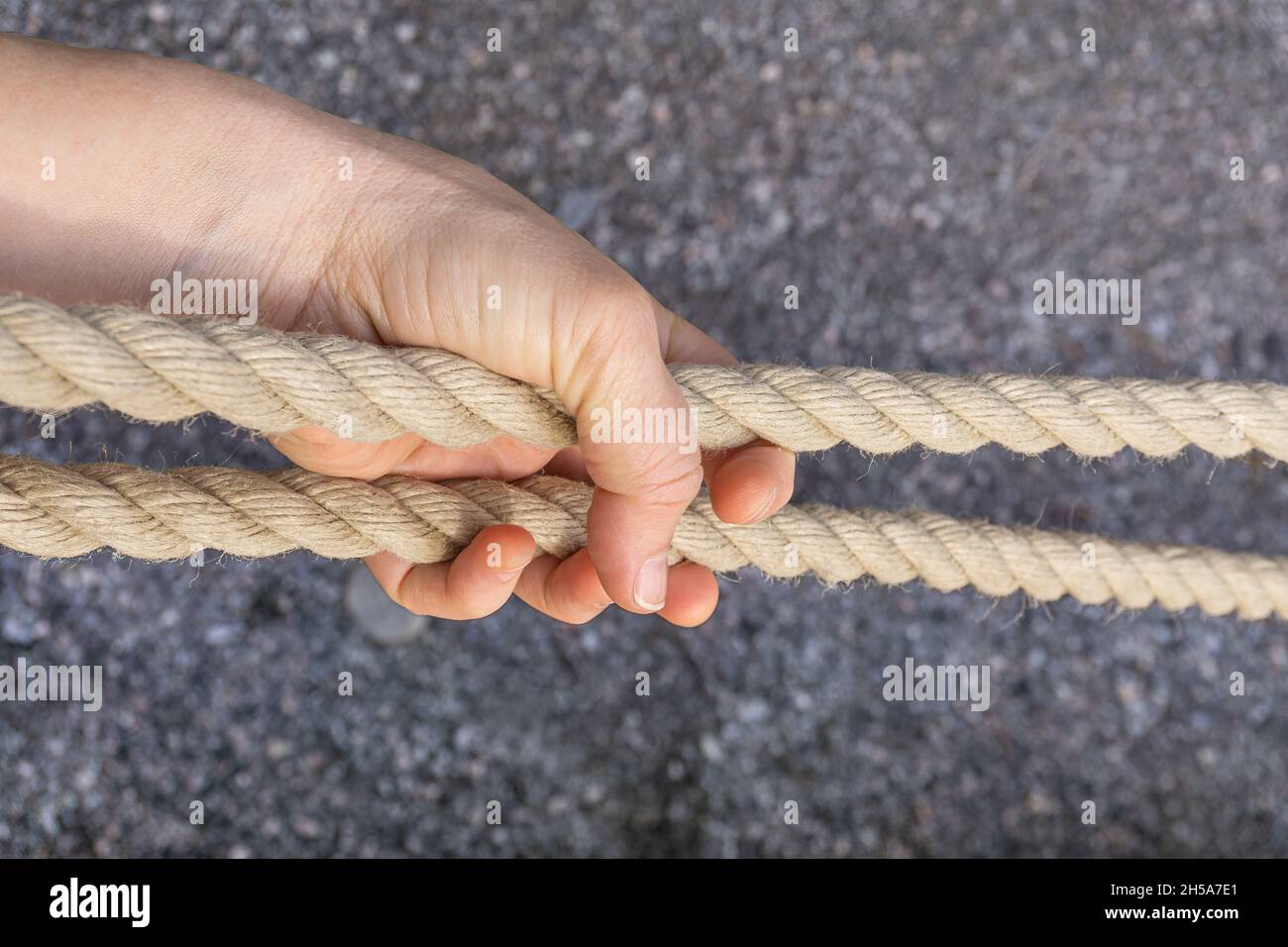 Hand holding rope hi-res stock photography and images - Alamy