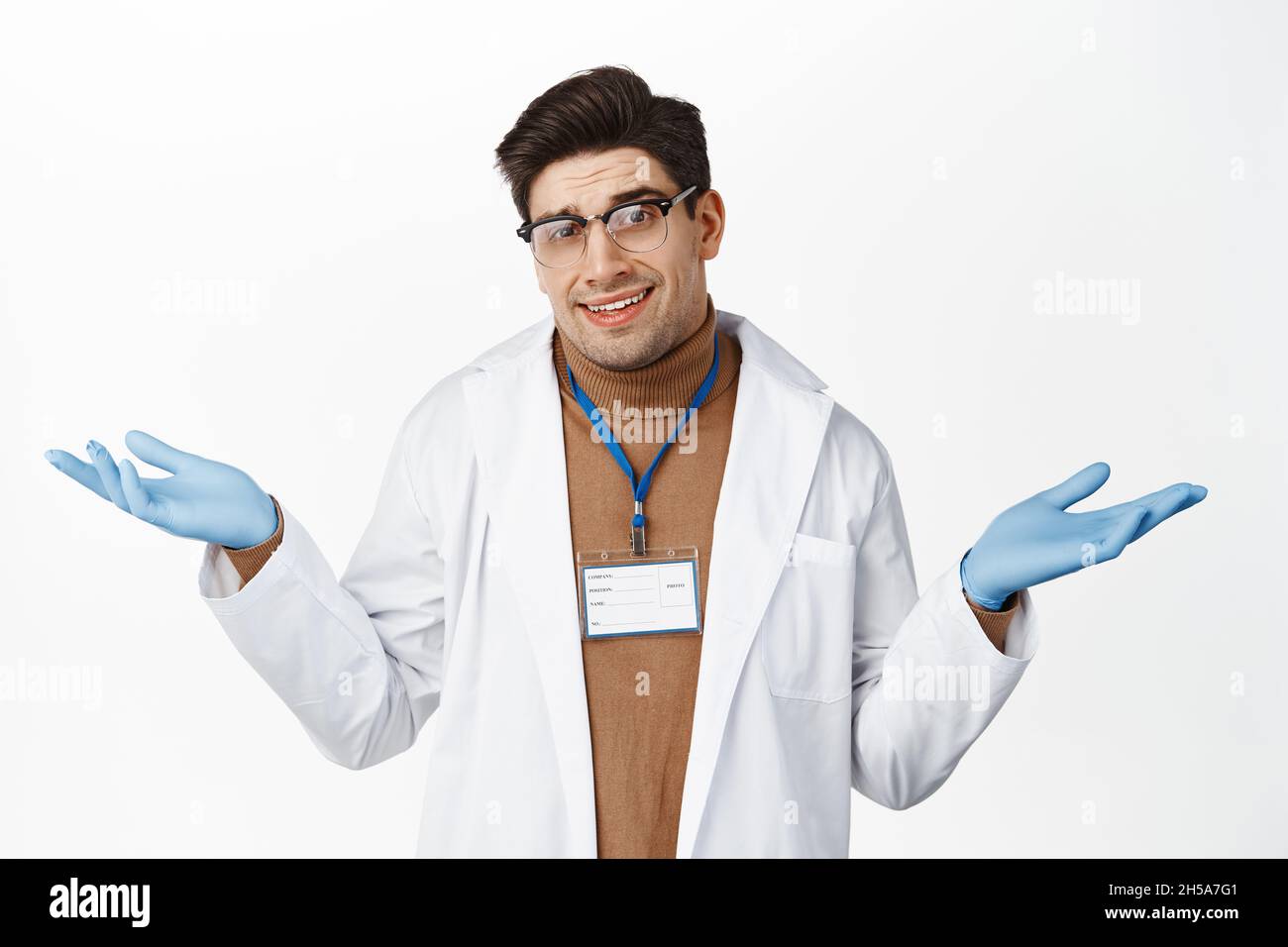 Image of doctor in glasses and medical uniform shrugging shoulders ...
