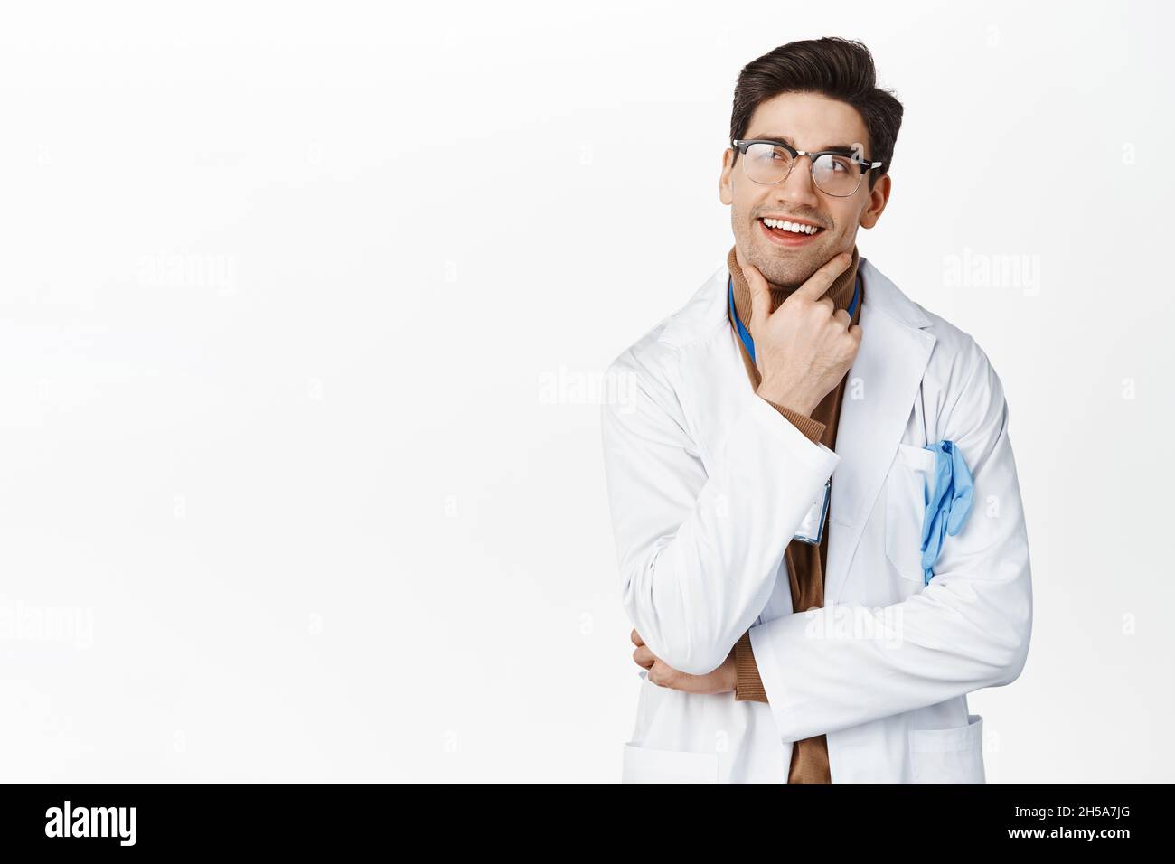 Image of thinking doctor with pleased smiling face, looking up ...