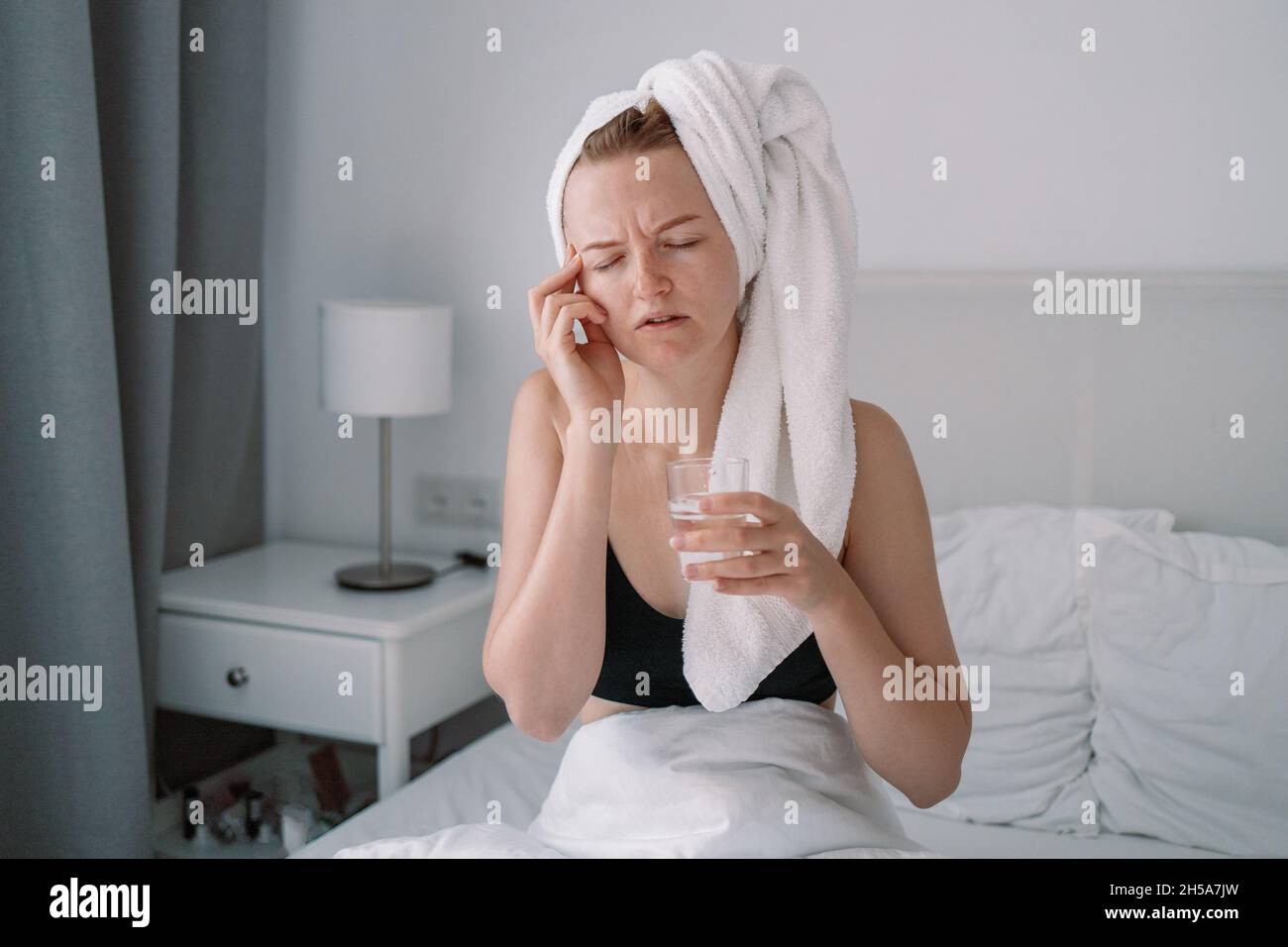 Depressed sad woman sitting in bed, waking up with insomnia, sick with ...