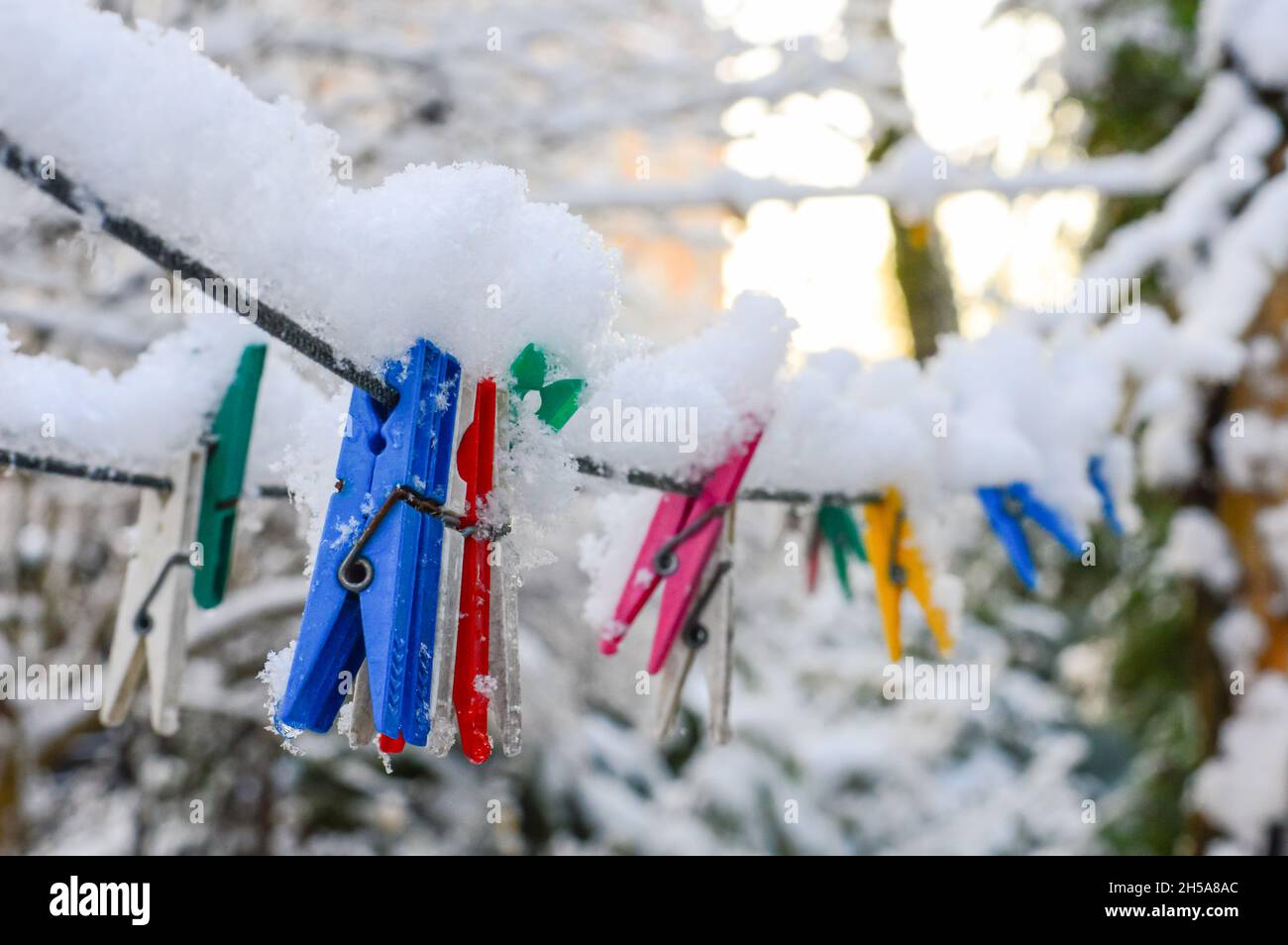 Plastic clothespins on a clothesline in frosty winter weather after a ...