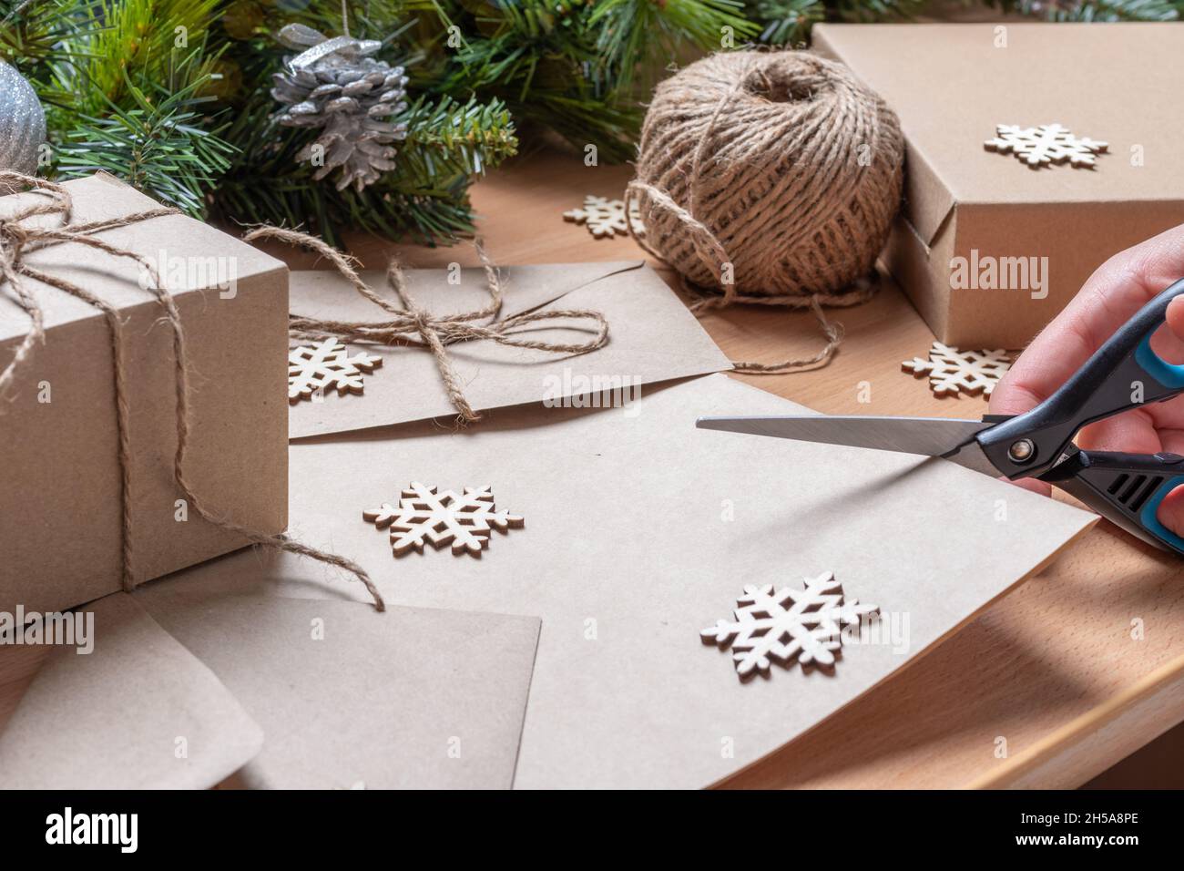 Packaging of ecological Christmas gifts - hand cutting recycled paper ...