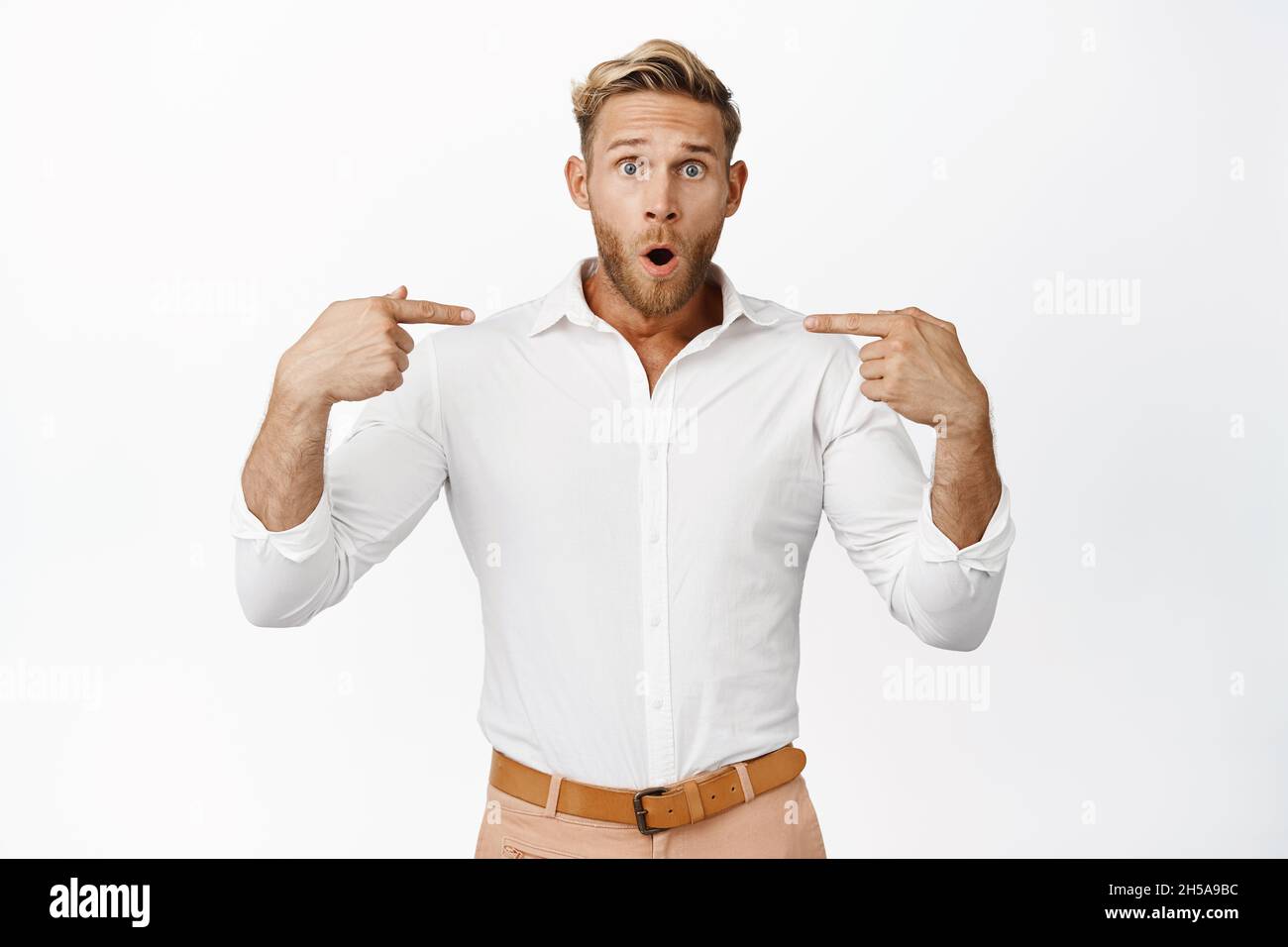 Image of surprised blond guy pointing fingers at himself, look amazed ...
