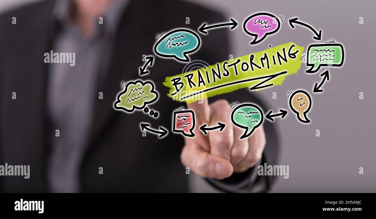 Man touching a brainstorming concept on a touch screen with his finger ...