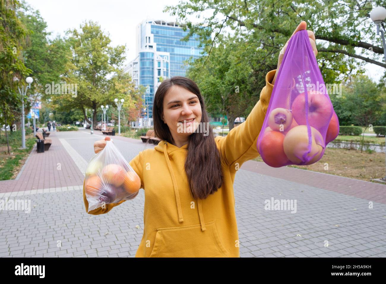 The woman keeps vegetables and fruits in a plastic bag and a cloth ...