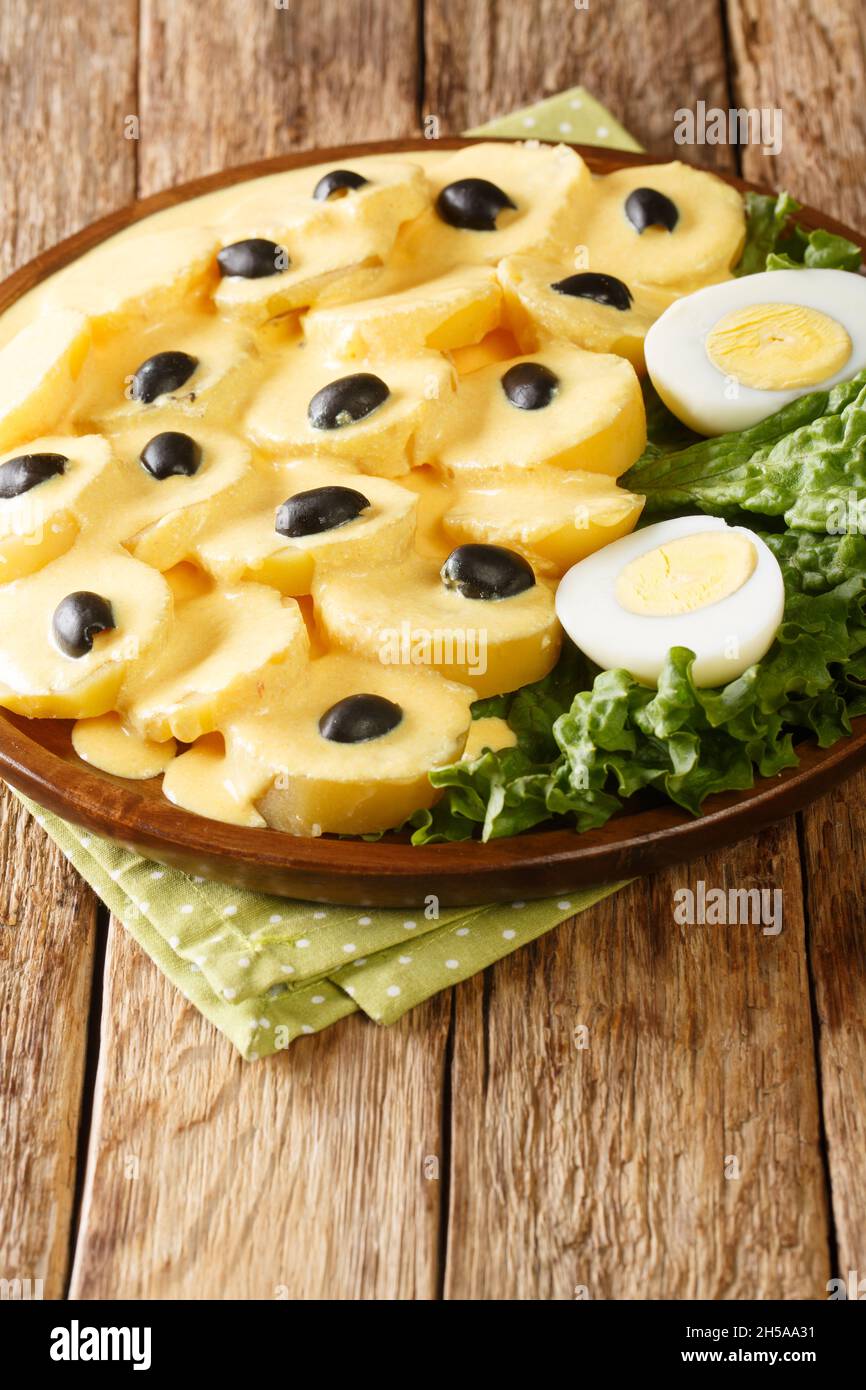 Papa a la Huancaina dish of sliced potatoes with a special sauce close ...