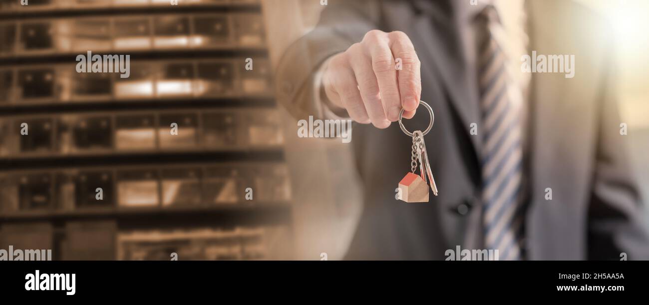 Real estate agent offering house keys; multiple exposure Stock Photo ...