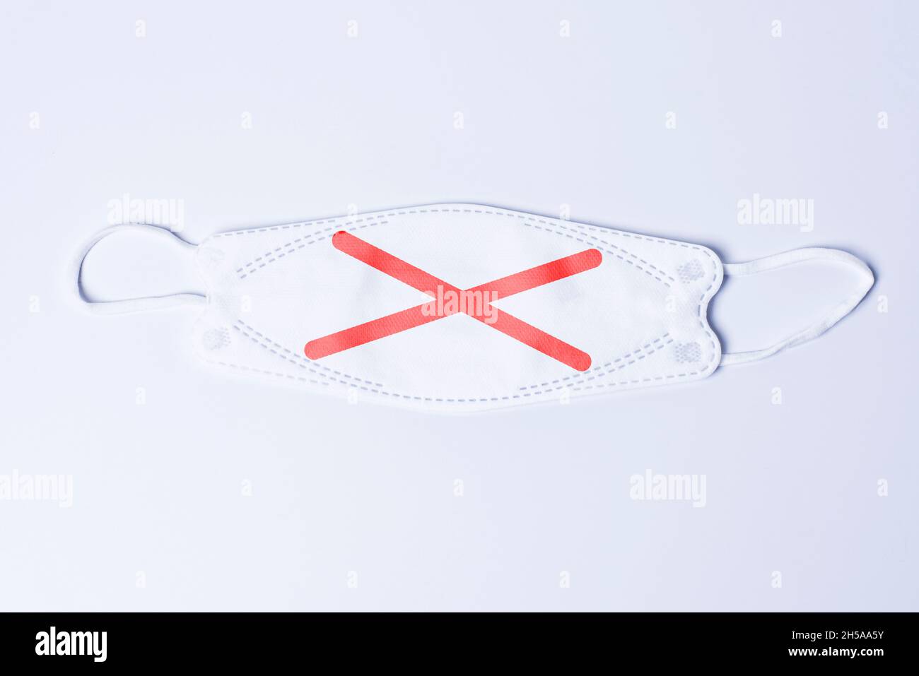 No masks. A medical protective face mask with red cross, symbol of the ...