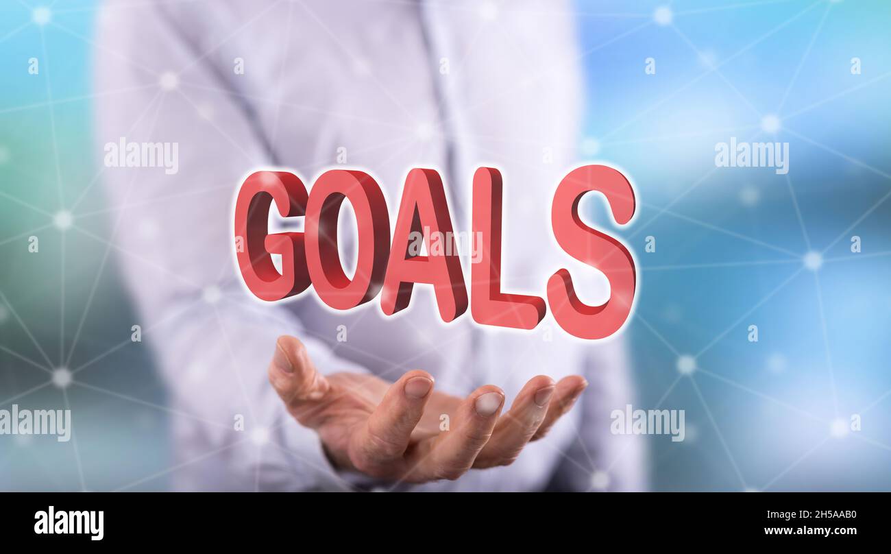 Goals concept above the hand of a man in background Stock Photo - Alamy