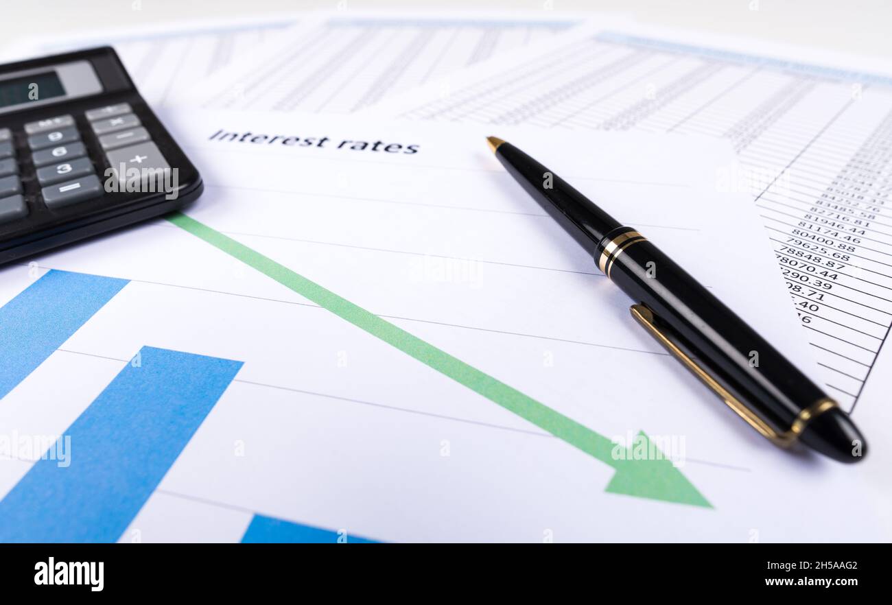 Interest rates documents with calculator Stock Photo - Alamy