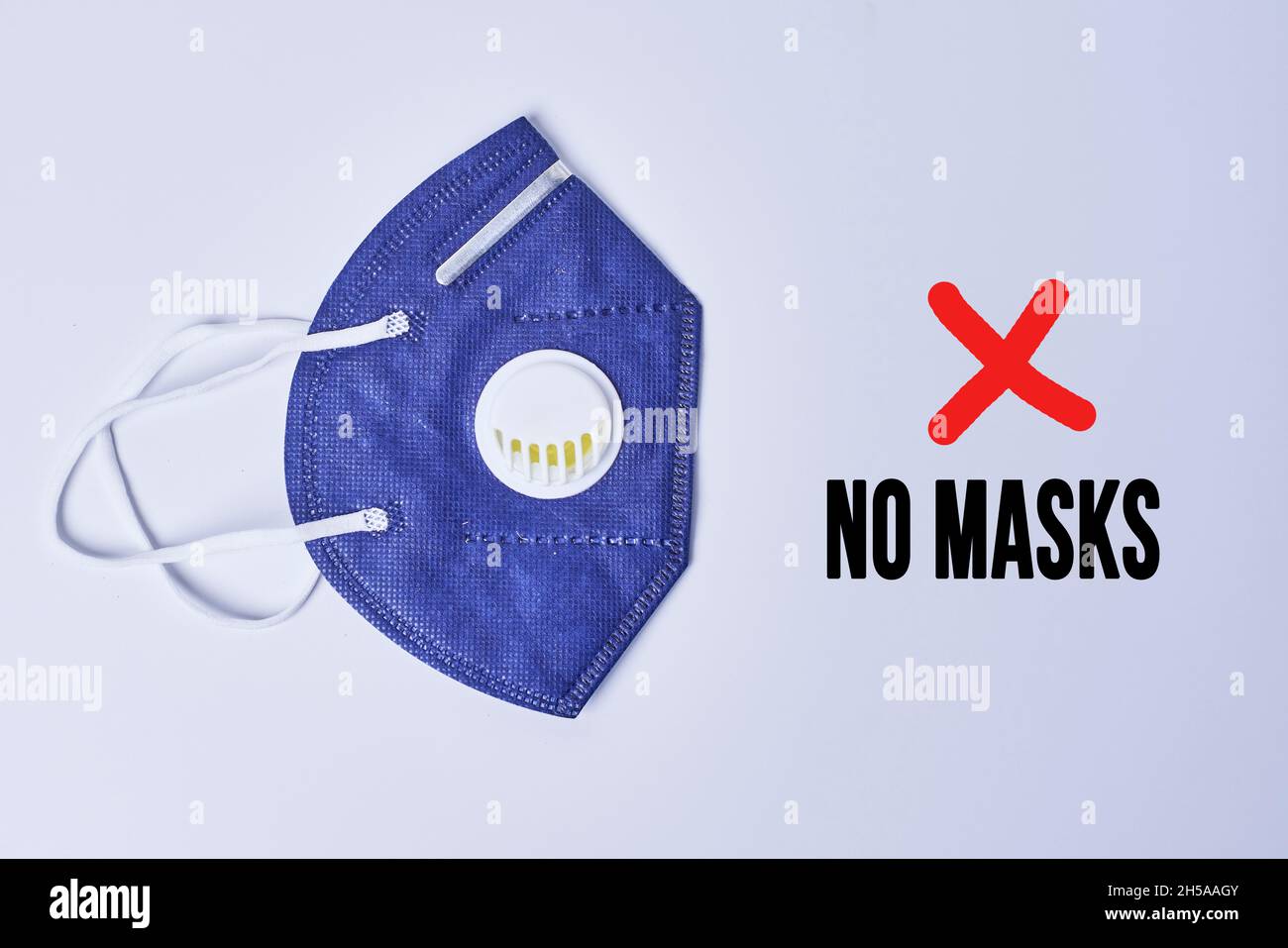 No masks. A medical protective face mask with red cross, symbol of the ...