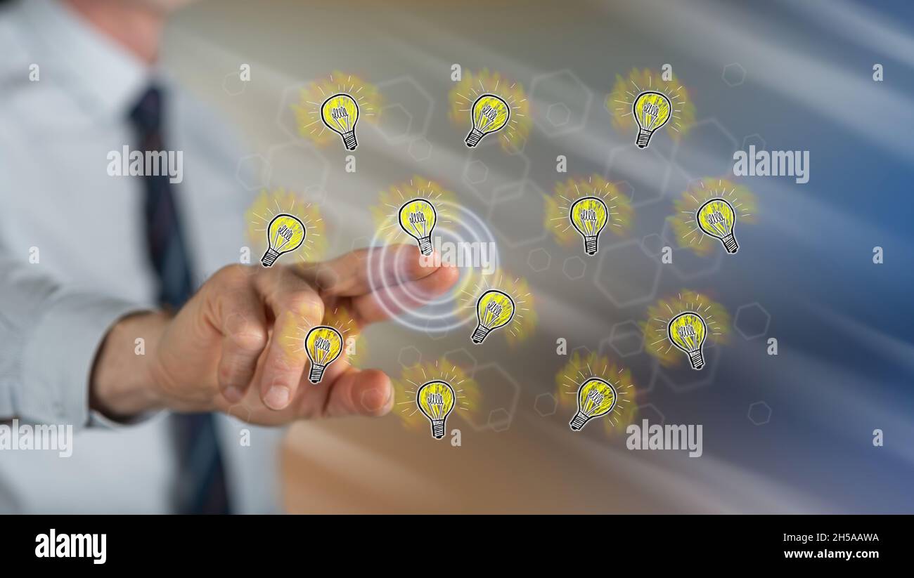 Man touching light bulbs on a touch screen with his finger Stock Photo ...