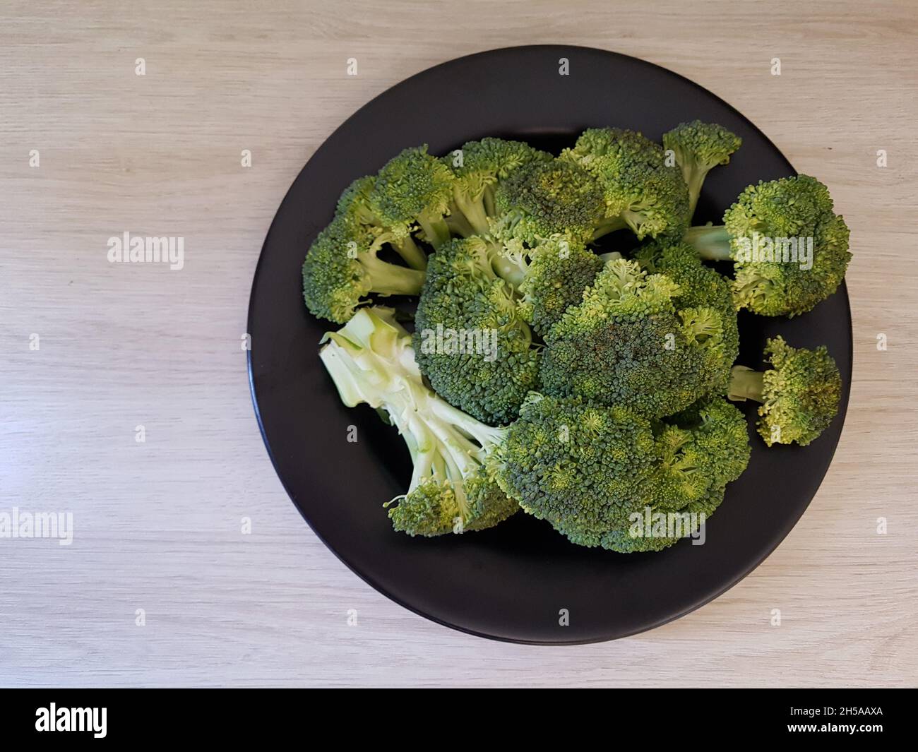 Broccoli: green, organic, isolated, ready to cook on a light wooden ...