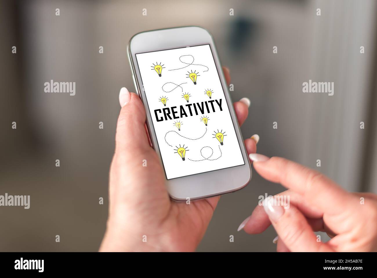 Creativity concept on a smartphone held by a hand Stock Photo - Alamy