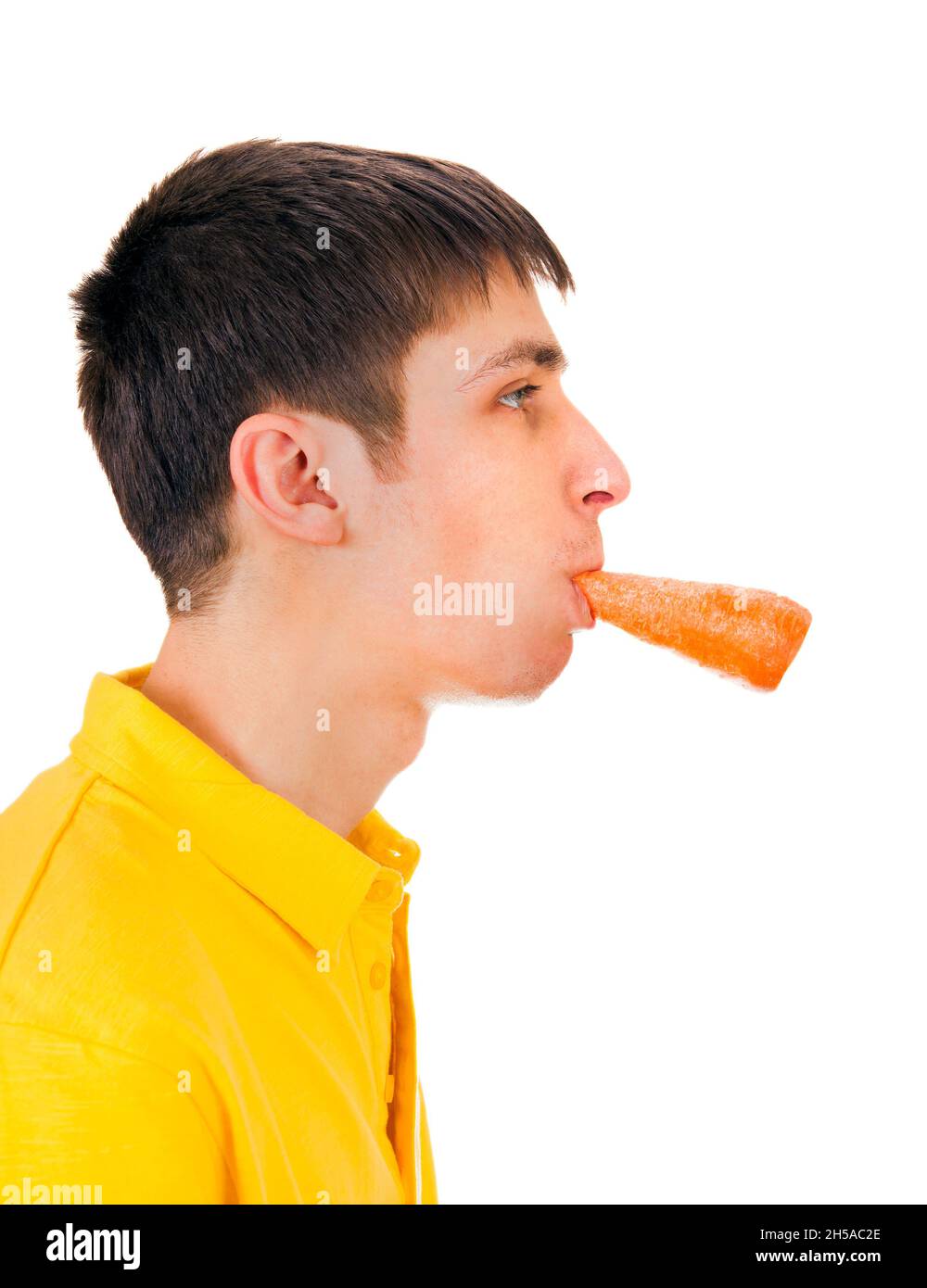 Young Man with a Carrot in his Mouth Isolated on the White Background ...