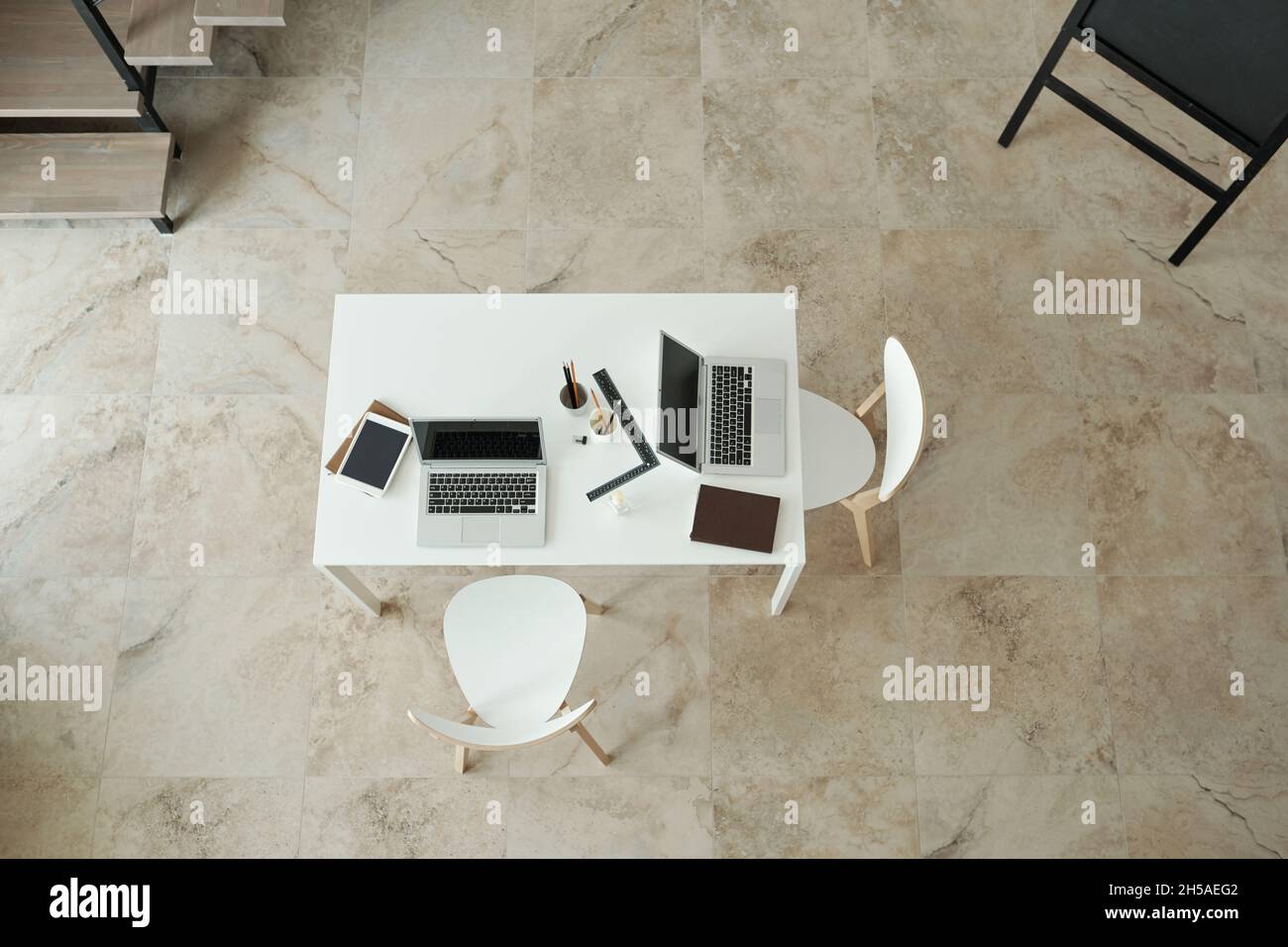 Overview of part of large modern office with table and chairs between ...