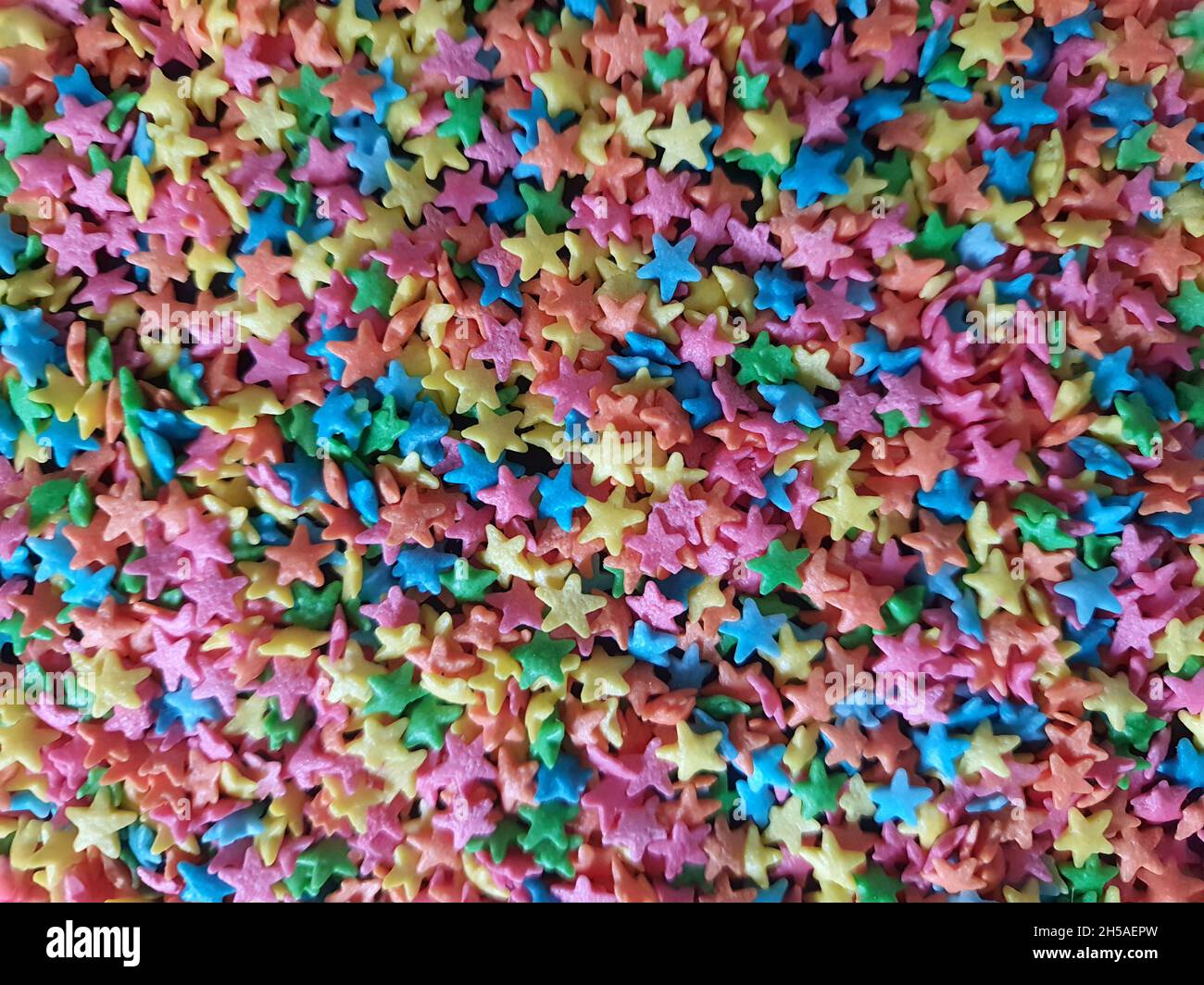 Colored mini stars, candy, full screen, top view. Backgrounds and ...