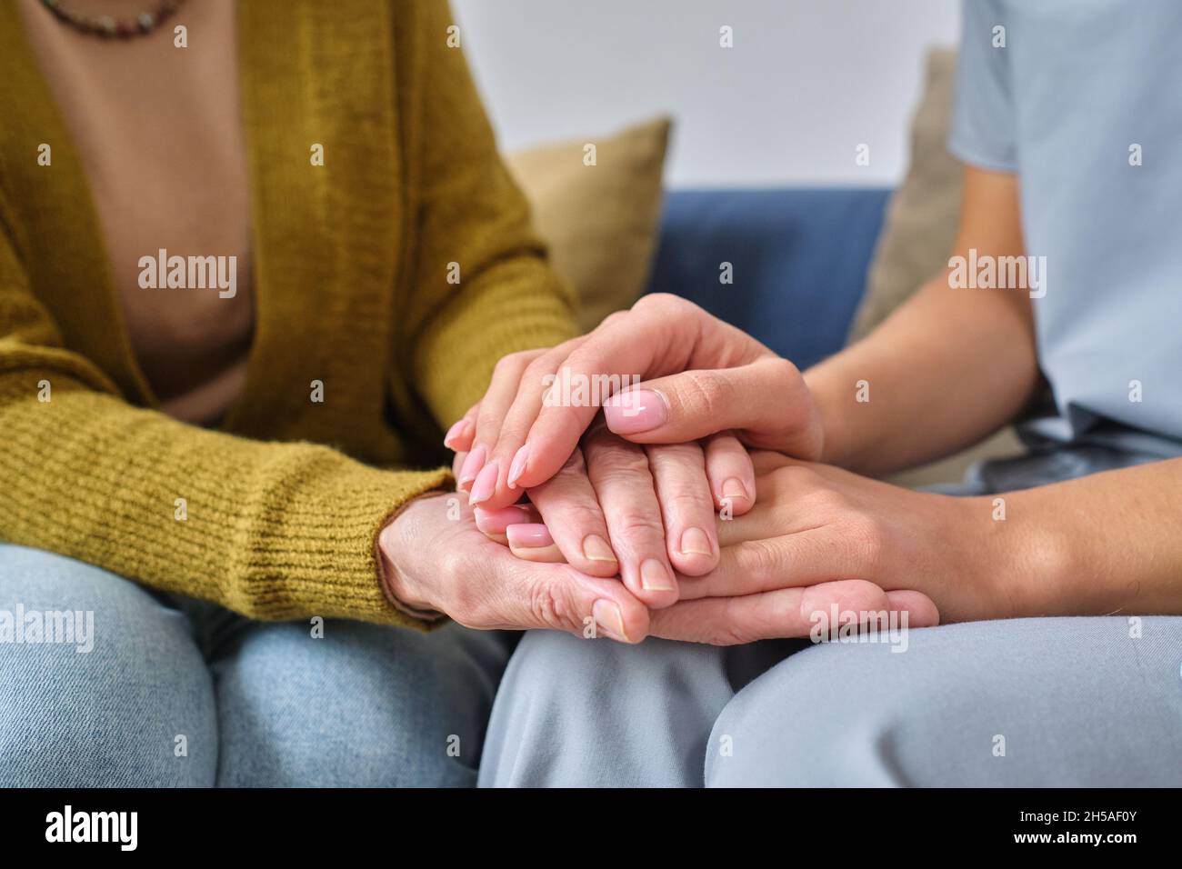 Close-up of nurse holding hands of senior woman, she supporting and ...