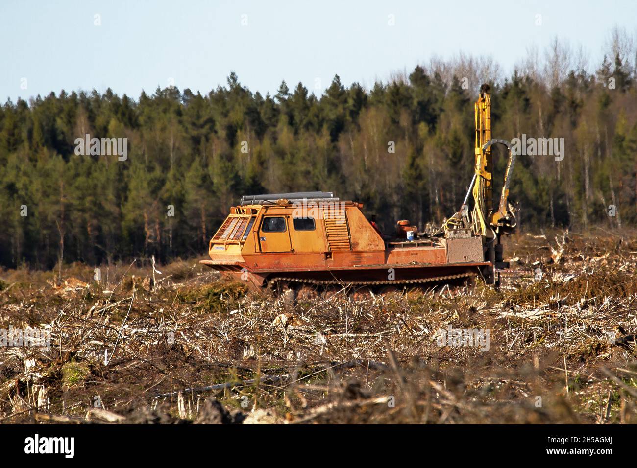 Drilling rig on crawler track on site of sawn forest where large-scale ...