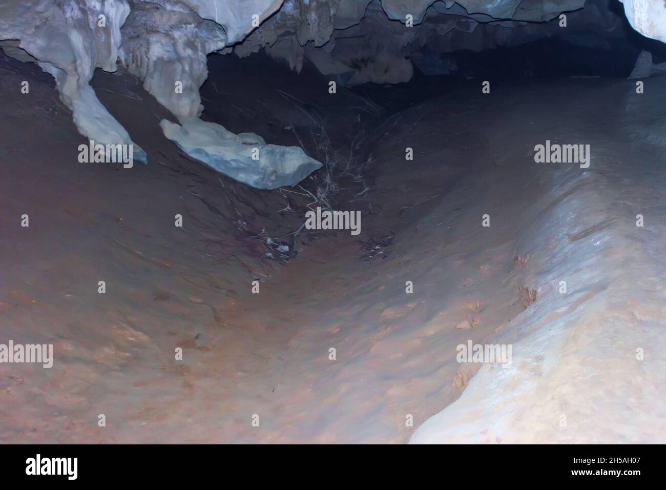 Speleology. Old cave washed by an underground river in the mountain ...