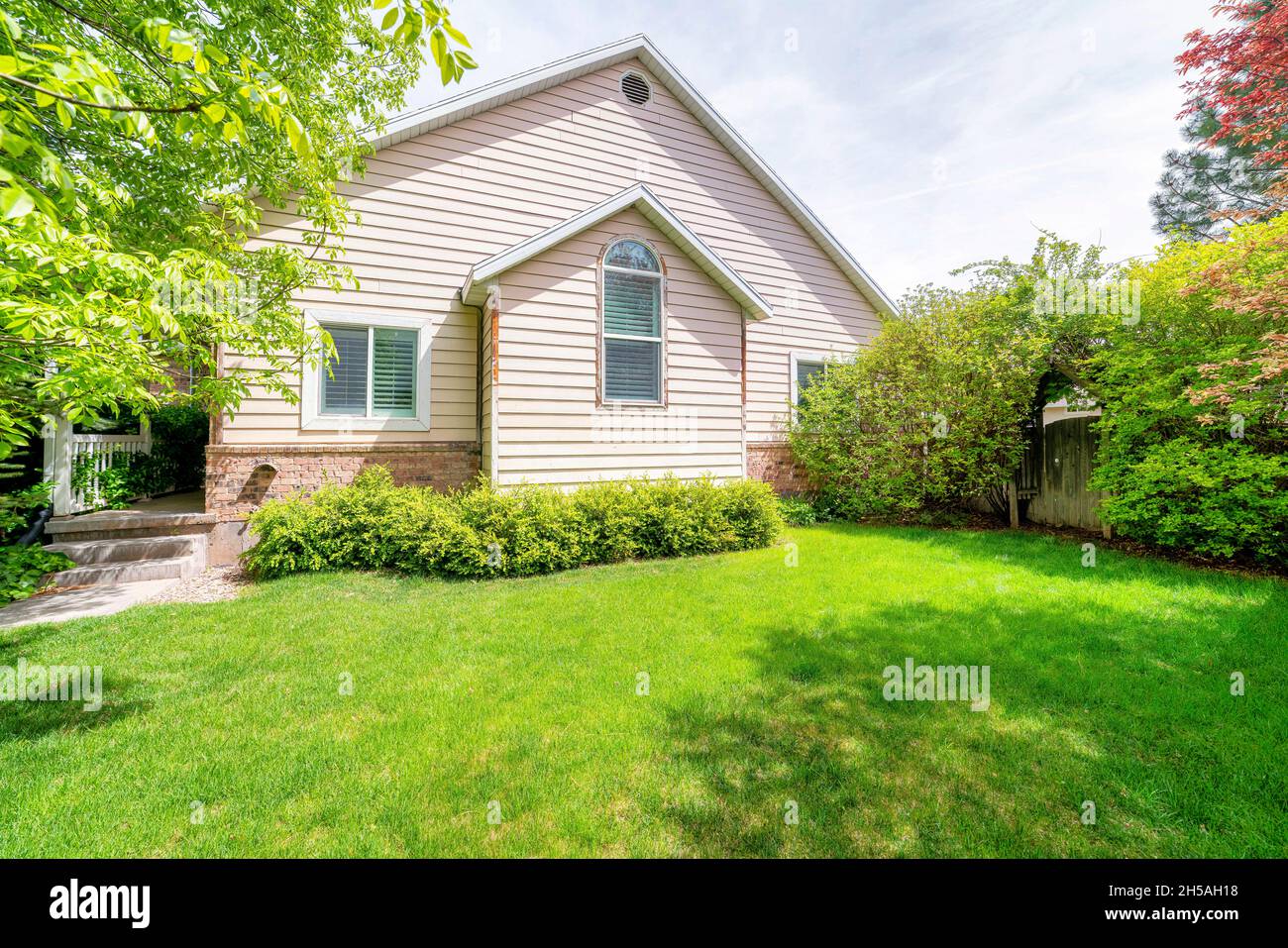 Front yard of a house with trees, plants and green lawn Stock Photo - Alamy