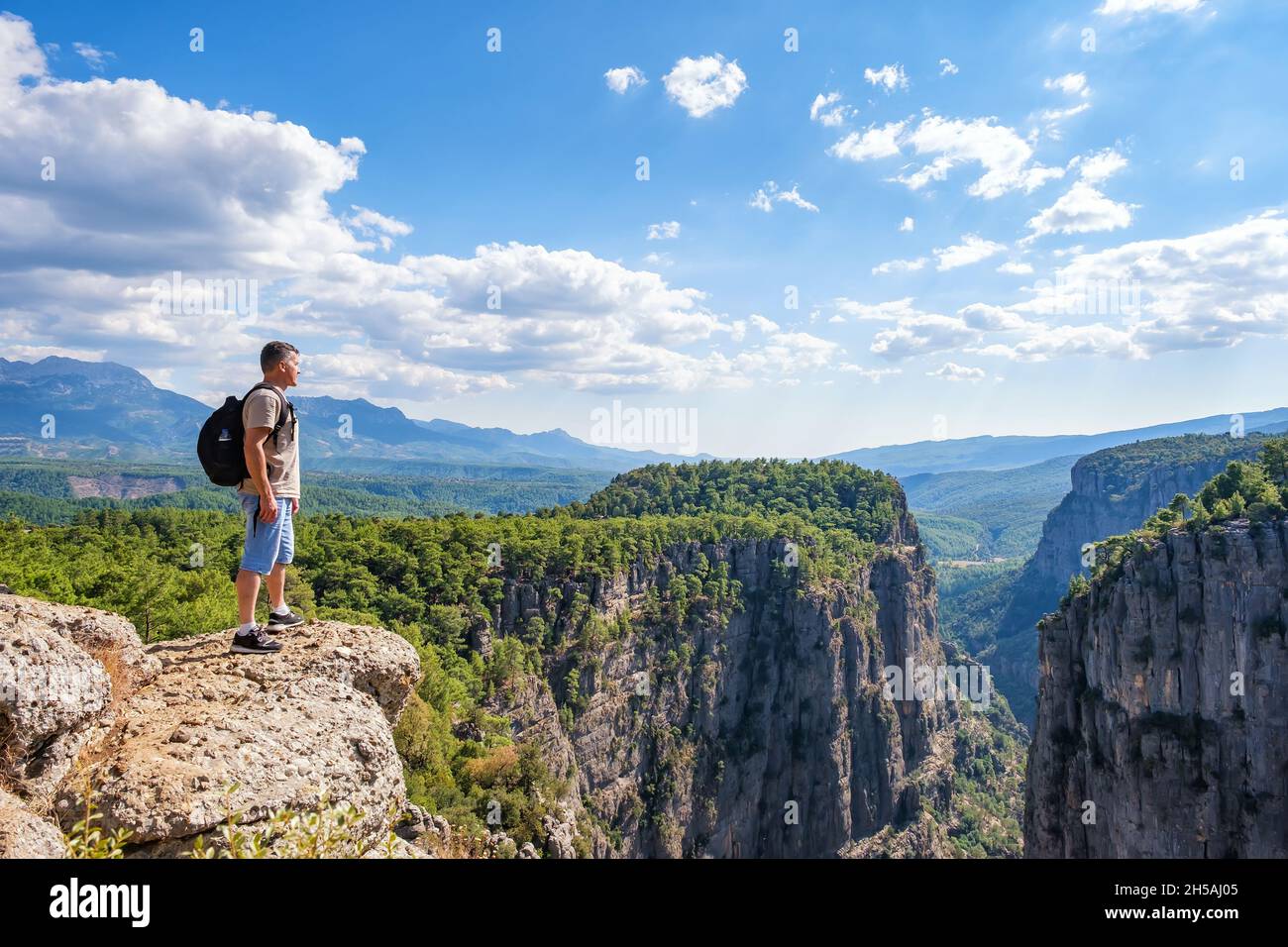Peaceful man standing on cliff Stock Photo - Alamy