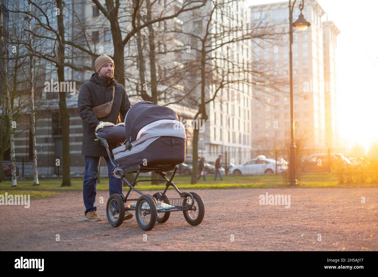 Happy young father with pram during the walk in nature Stock Photo - Alamy