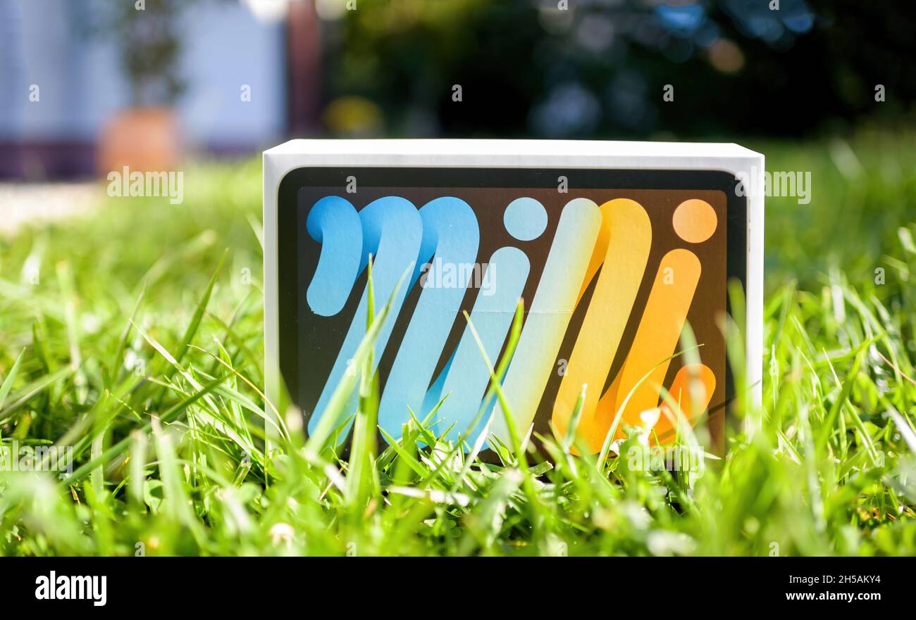 Gift in garden with tall grass - cardboard box of new Apple Computers ...